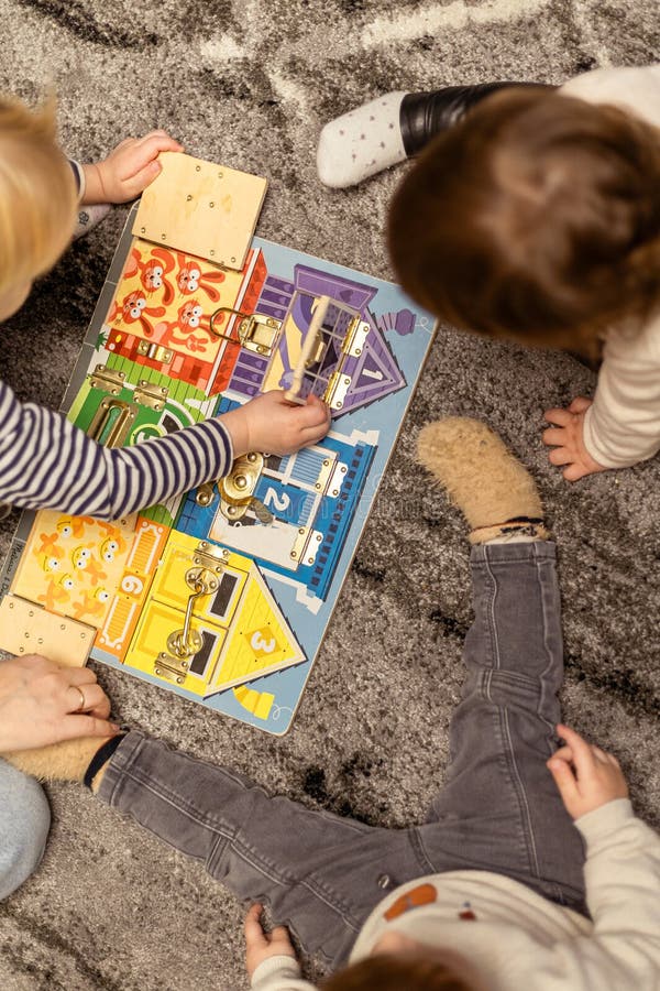 Children Engage in Playful Learning with a Colorful Puzzle in a Cozy ...