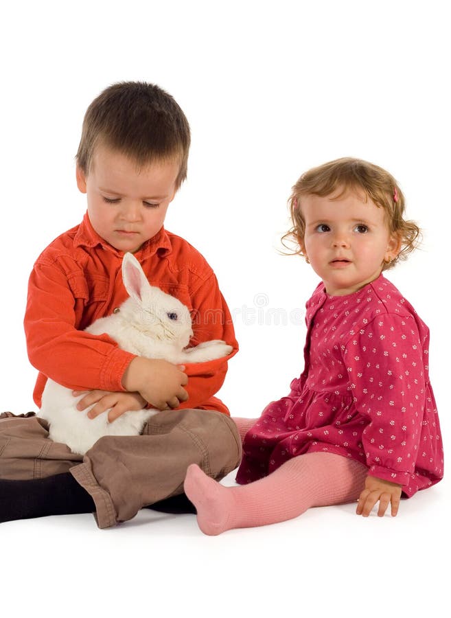 Two Children Getting Acquainted with a Bunny Stock Image - Image of ...