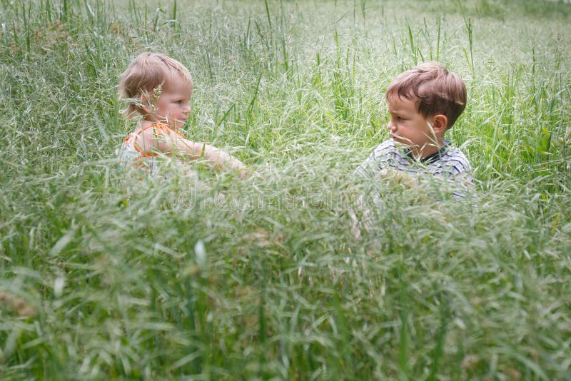 Two children in grass stock photo. Image of brother, childhood - 23280742