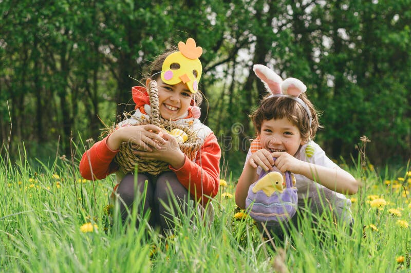 Two Children Hunt for Easter Eggs in a Spring Garden. Easter Tradition ...