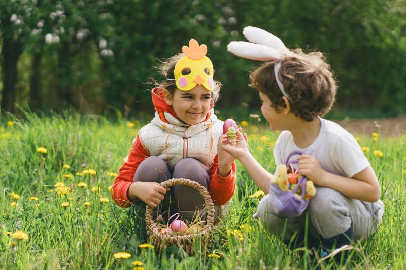 Two Children Hunt for Easter Eggs in a Spring Garden. Easter Tradition ...