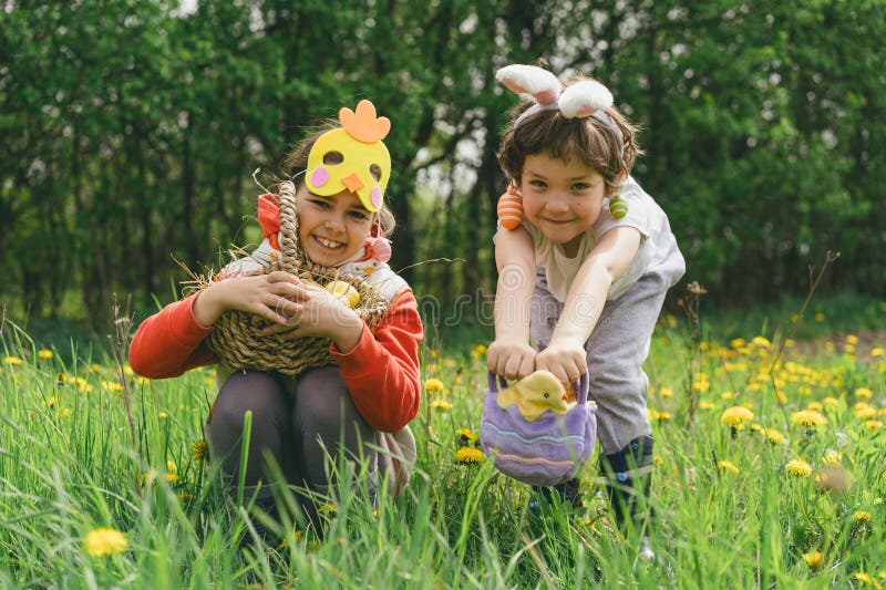 Two Children Hunt for Easter Eggs in a Spring Garden. Easter Tradition ...