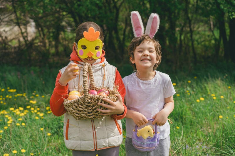 Two Children Hunt for Easter Eggs in a Spring Garden. Easter Tradition ...