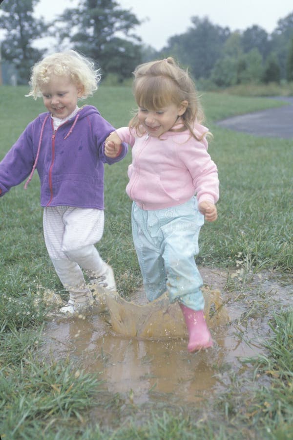 Two Children Jumping Over a Puddle, Washington D.C Editorial Photo ...