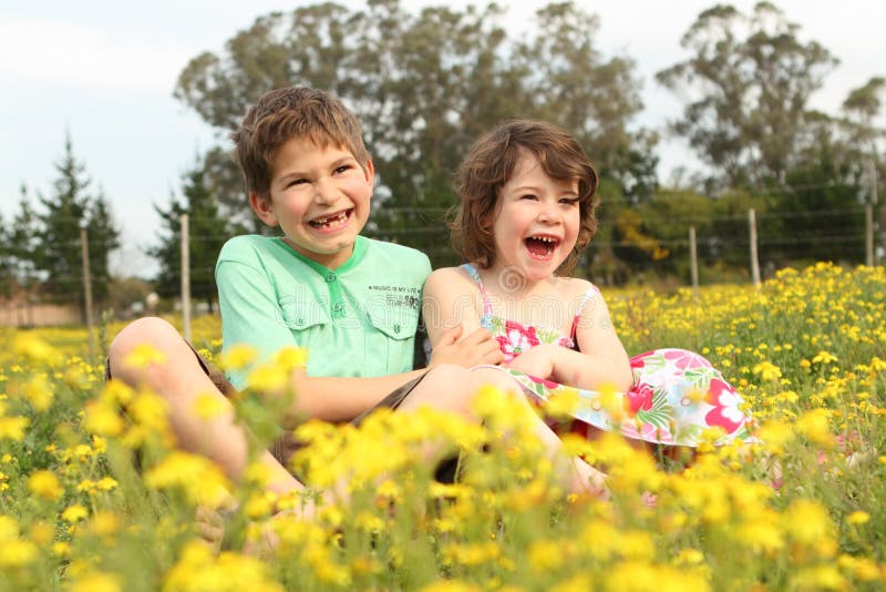 Two children laughing stock image. Image of daisy, children - 21260705