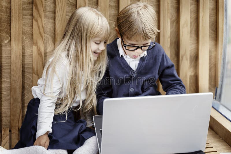 Two Children are Looking at a Laptop and Smiling Stock Image - Image of ...