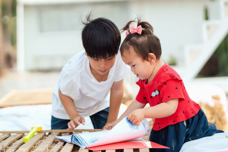 Two Children Open Book Reading Stock Image - Image of asian, classroom ...
