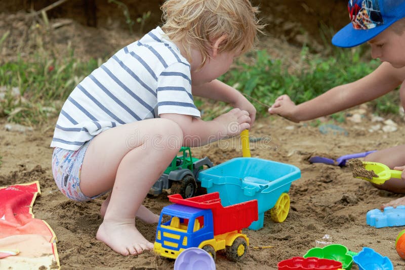 Two Children Play in the Sand with Plastic Toys Stock Photo - Image of ...
