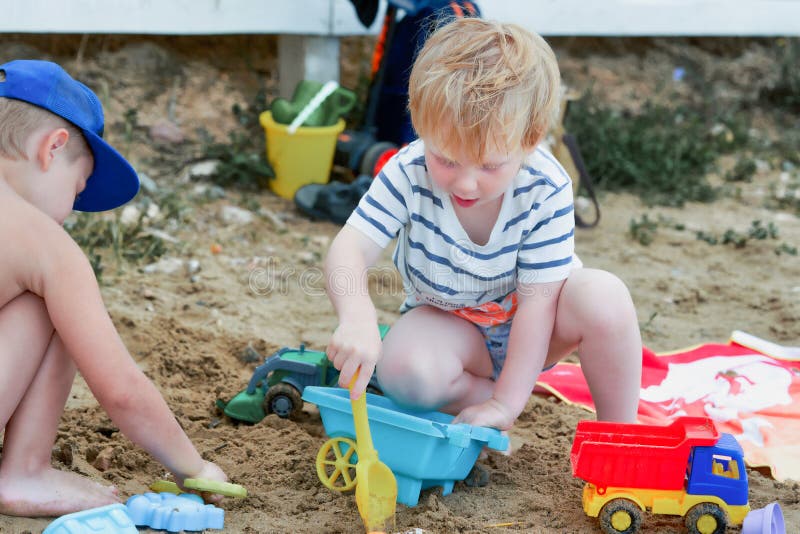 Two Children Play in the Sand with Plastic Toys Stock Photo - Image of ...