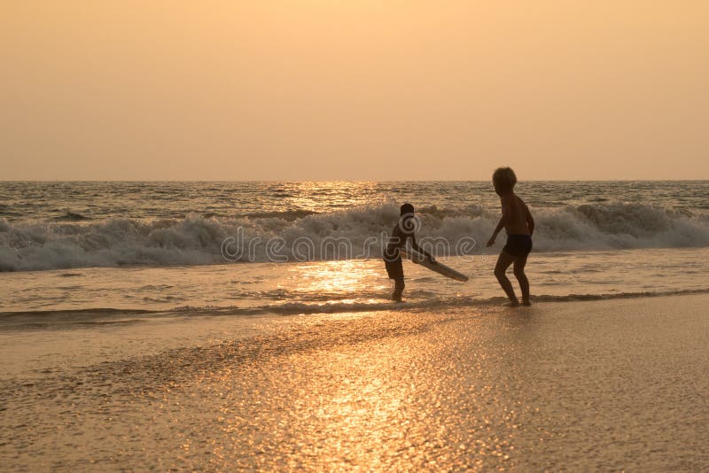 Two Children is Playing on the Beach in Sunset Editorial Stock Image ...