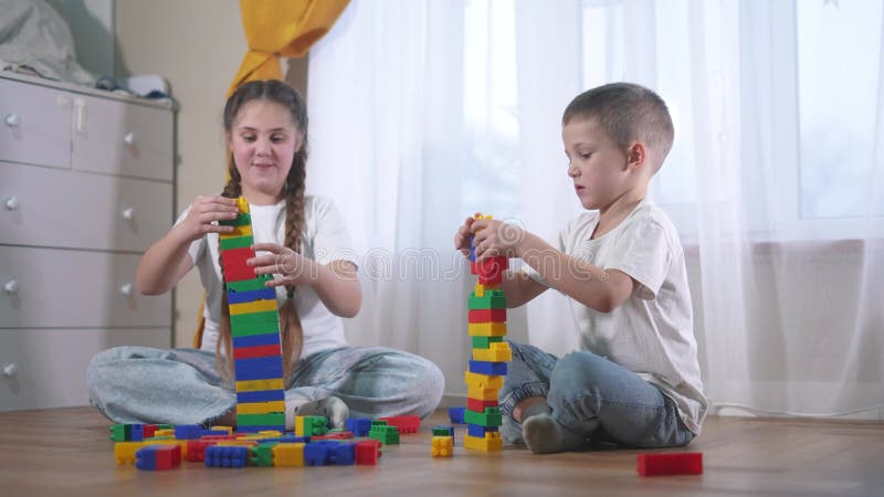Two Children Playing with Blocks. a Group of Children are Assembling a ...