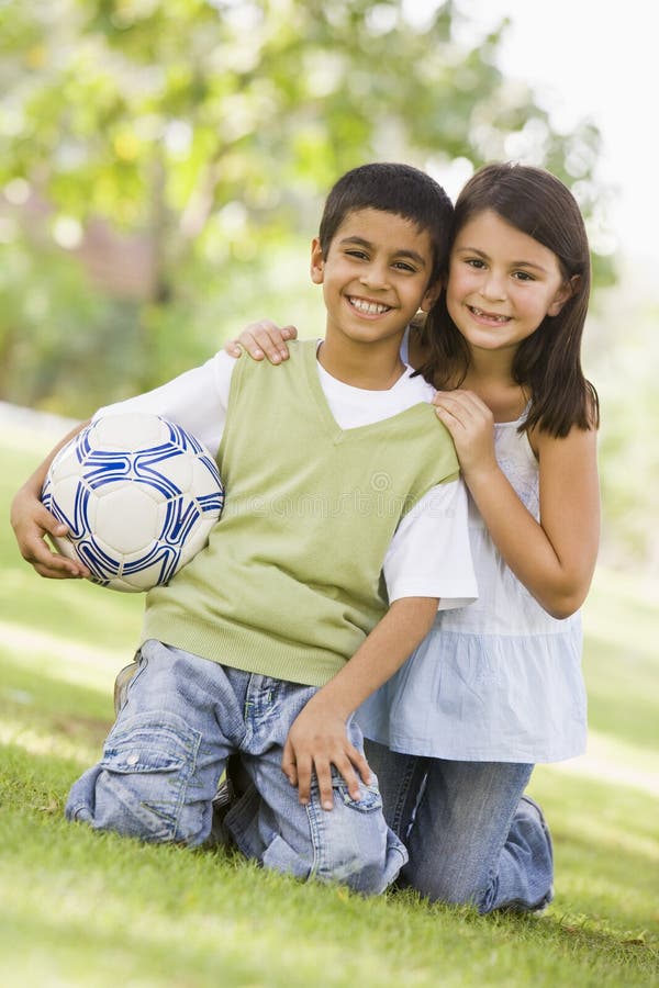 Two Children Playing Football in Park Stock Photo - Image of outdoors ...