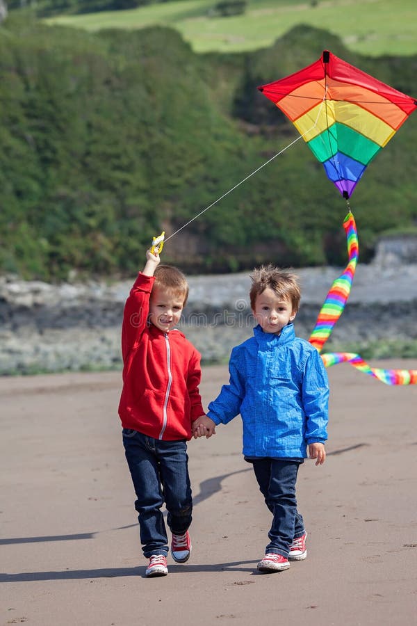 Two Children Playing with a Kite on the Beach Stock Image - Image of ...