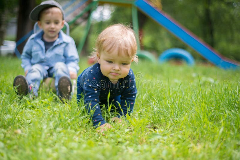 Two Children Playing on the Lawn Stock Photo - Image of months, happy ...