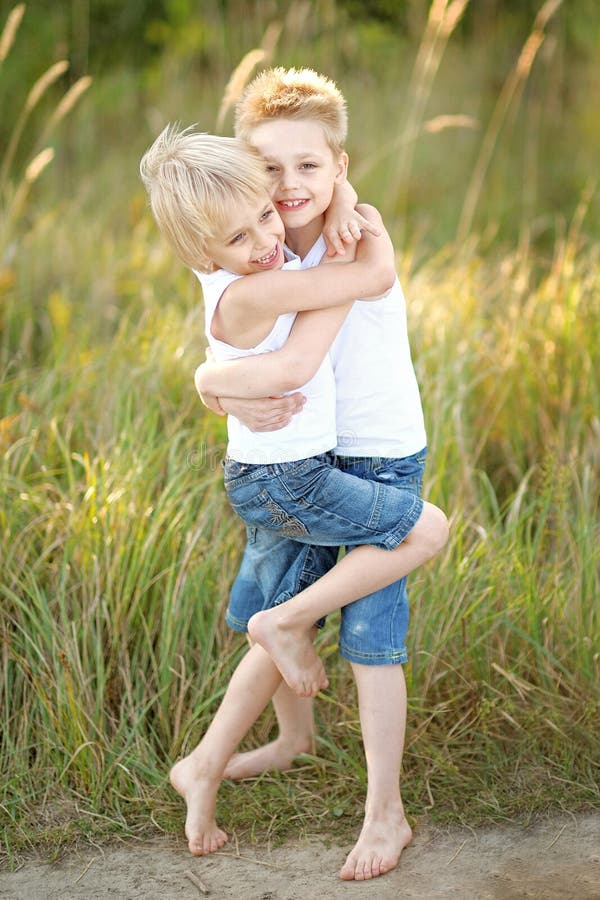Two Children Playing on Meadow Stock Image - Image of field, smile ...