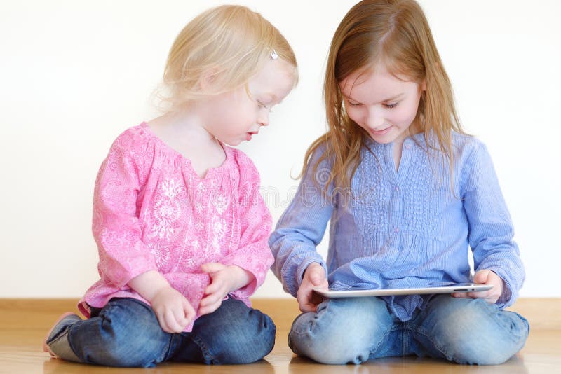 Two Children Playing with a Tablet at Home Stock Image - Image of ...