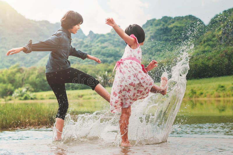 Two children playing water stock photo. Image of little - 141082680