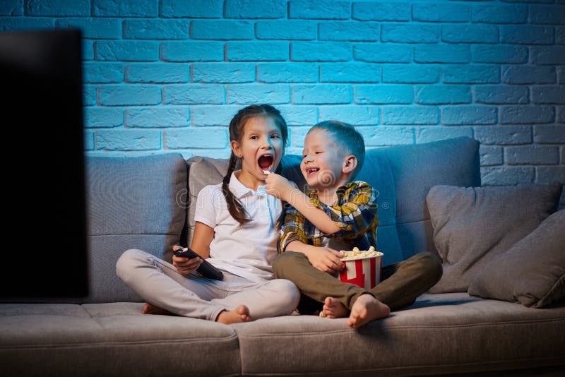 Two Children with Remote Control Watching TV Stock Image - Image of ...