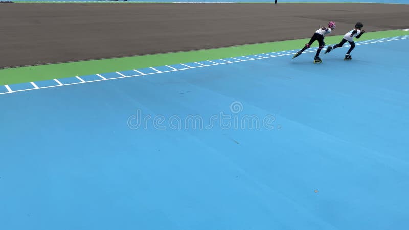 Two Children Rolling Synchronically at the Stadium. Training of Young ...