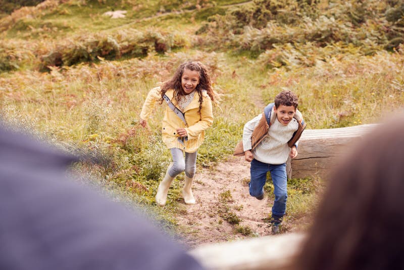 Two Children Running Along Path in Countryside on Winter Vacation Stock ...