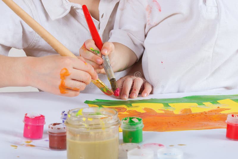 Two Children S Hands Hold Brushes. Children Draw Together Stock Image ...