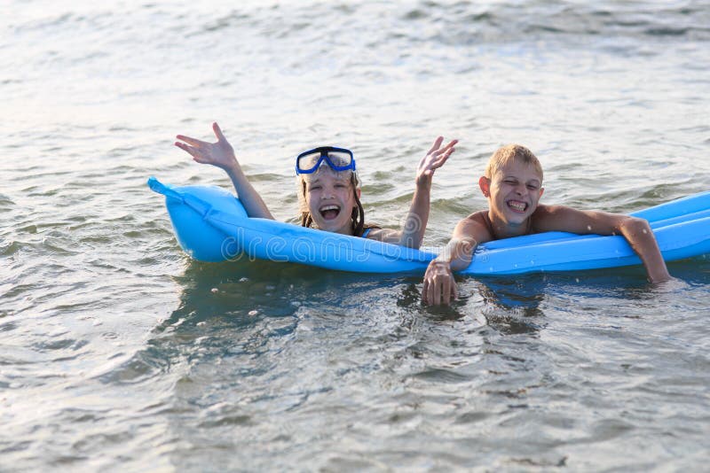 Two children in the sea stock photo. Image of children - 122022124