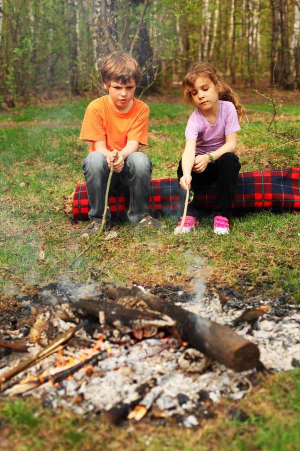 Two Children Sit Around Campfire Stock Photo - Image of concentrated ...