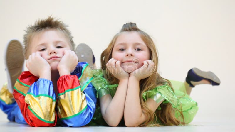 Two Children Sit on Their Belly and Hold Their Stock Video - Video of ...