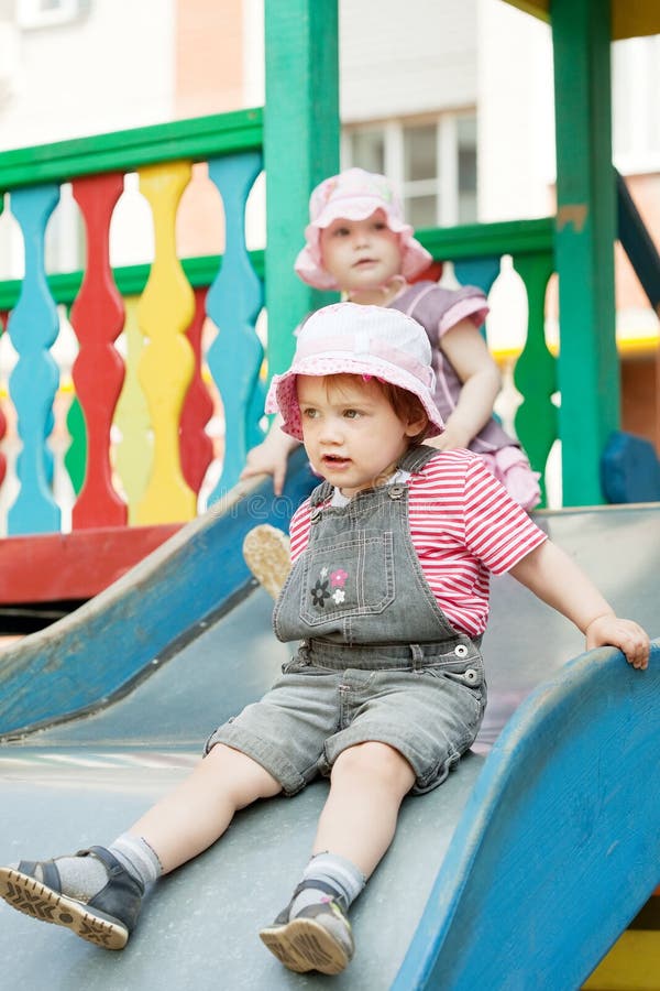 Two children on slide stock photo. Image of playful, playground - 25584290