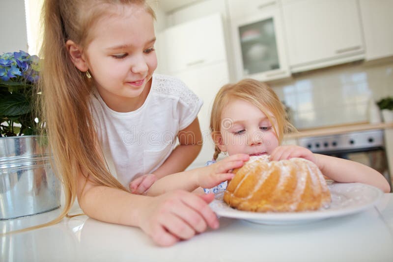 Two Children Snacking on Cake in the Kitchen Stock Image - Image of ...