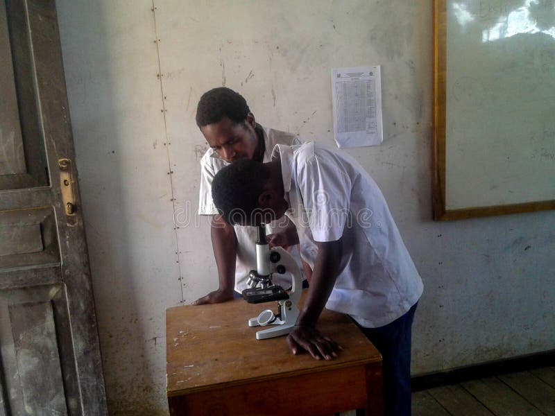 Two Children are Using a Microscope in the Interior of Papua Editorial ...