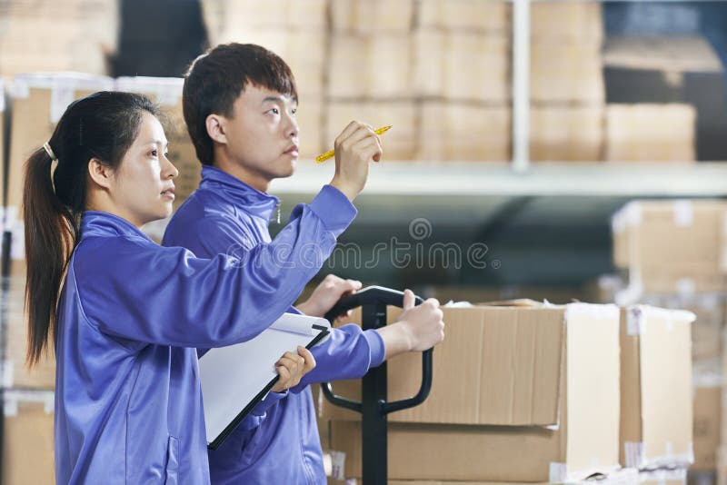 Two Chinese Workers in Warehouse Stock Photo - Image of lifting ...