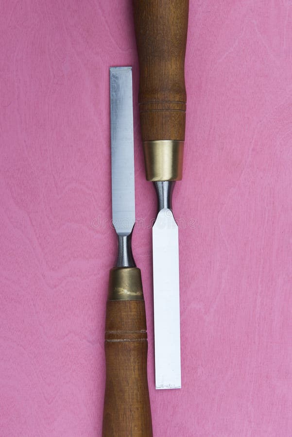 Two Chisels on a Pink Background Stock Image - Image of visible, brown ...