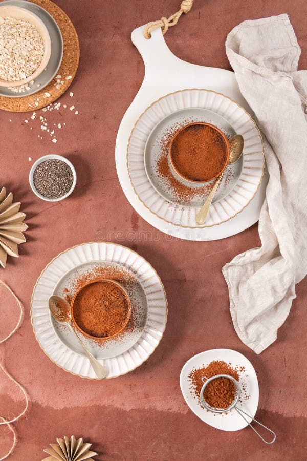 Two Chocolate Desserts with a Dusting of Cocoa Powder on White Plates ...