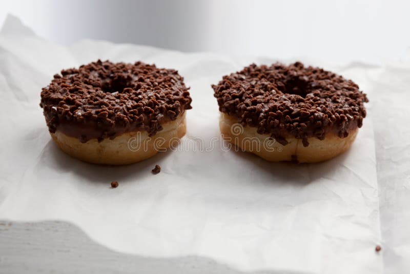 Two chocolate doughnuts stock photo. Image of festive - 52473960
