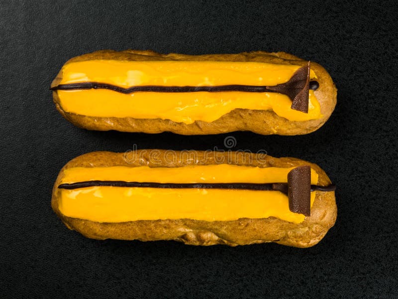 Two Choux Pastry Orange Eclairs Stock Image - Image of looking, flat ...