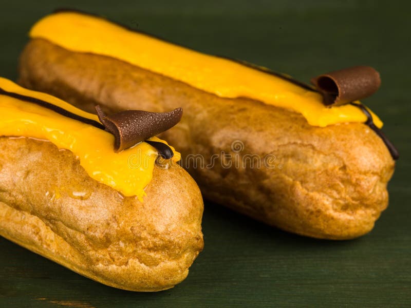 Two Choux Pastry Orange Eclairs Stock Image - Image of space, desserts ...