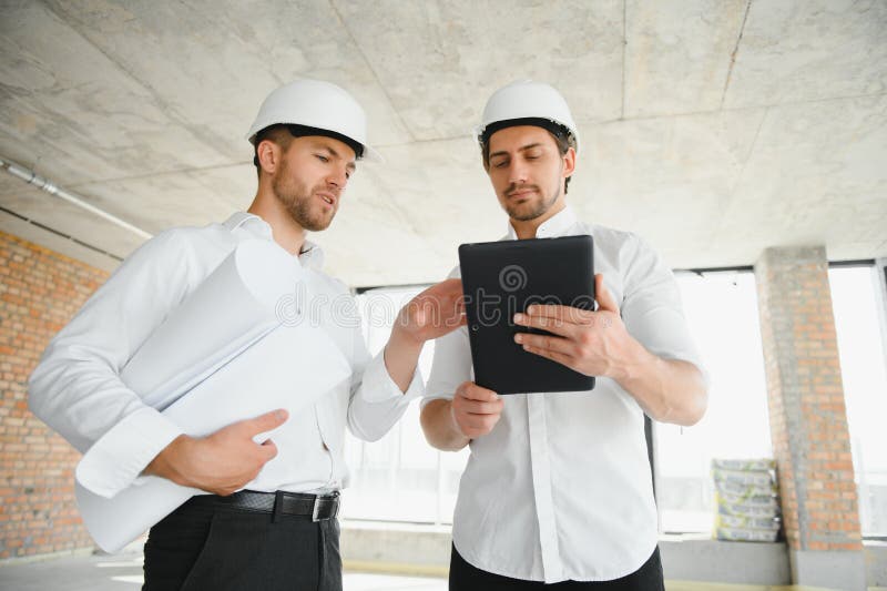Two Civil Engineers or Architects Man Inspecting Construction of House ...