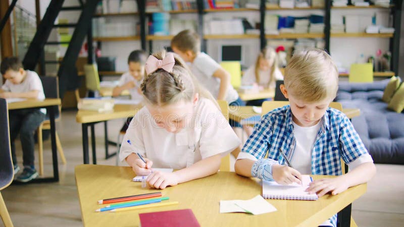 Two Happy Elementary School Classmates, a Boy and a Girl, Sitting at a ...