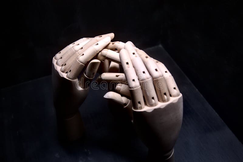 Two Closed Wooden Hands in a Shy Stance while Two Other Hands are ...
