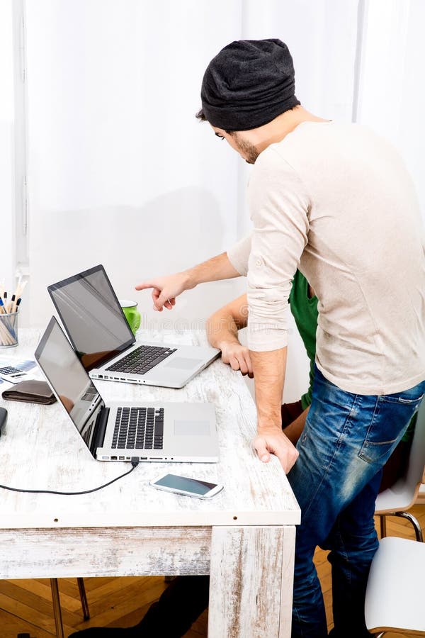 Two Co-workers Discussing Something in the Office Stock Image - Image ...