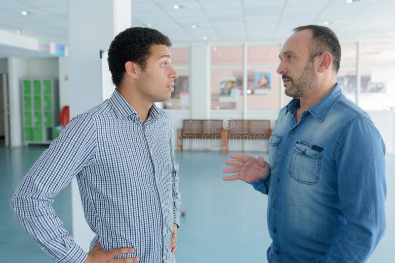 Two Co-workers Talking Indoors Stock Photo - Image of management ...