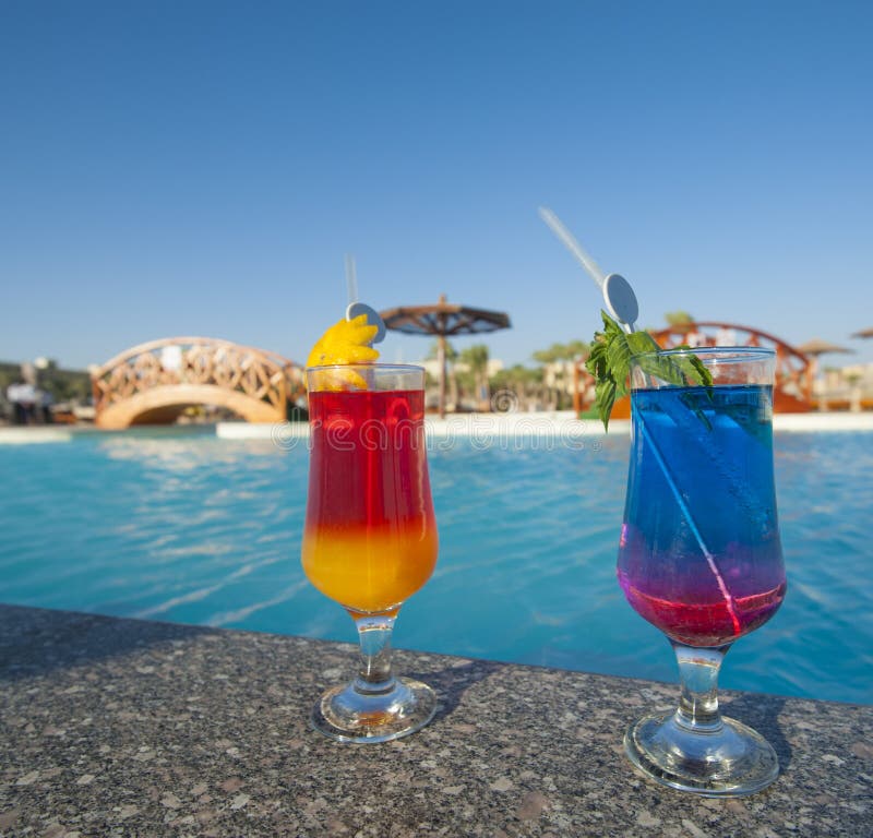 Two Cocktail Drinks by a Tropical Pool Stock Photo - Image of orange ...