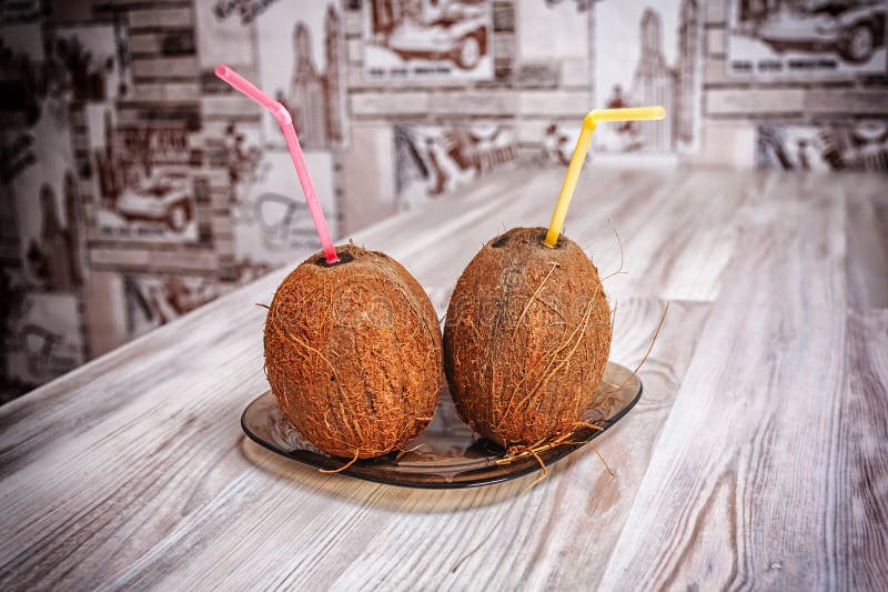 Two Coconuts Lie on a Dark Plate. Stock Photo - Image of hairy, straw ...