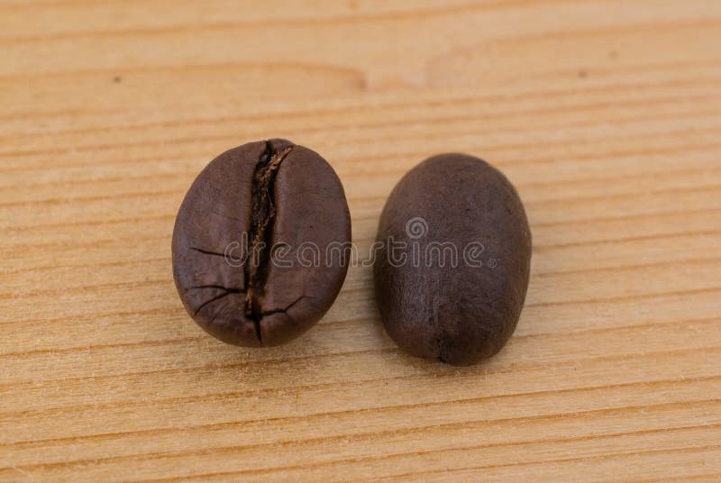 Two Coffee Beans in Differen Positions on Wooden Table Stock Image ...