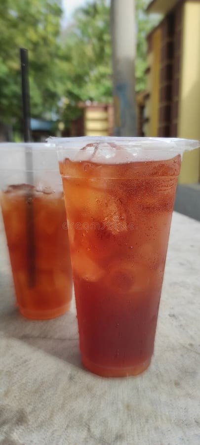 Two Cold Tea Drinks with Ice Cubes in Plastic Cups, Placed on a ...