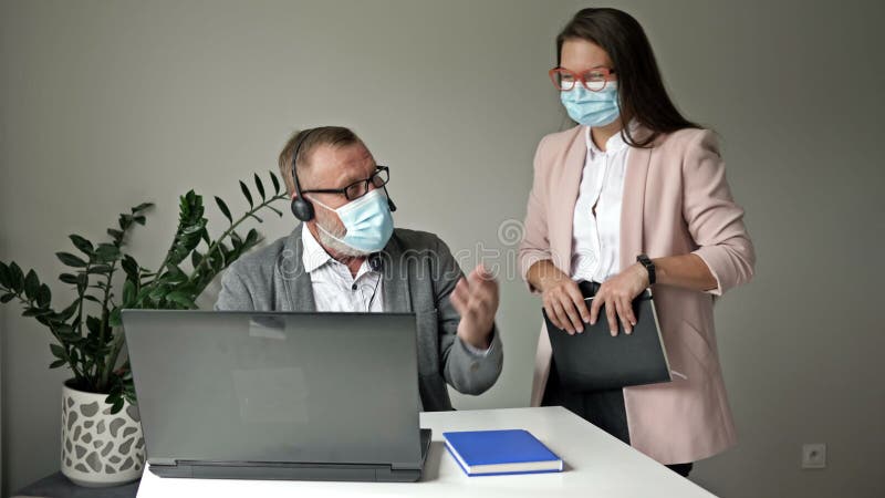 Two Colleagues Avoid a Handshake when Meeting in the Office and Greet ...