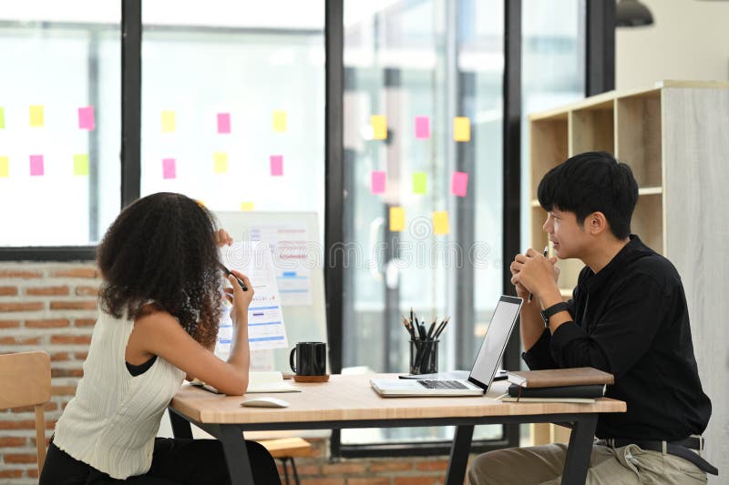 Two Colleagues Collaborating on Business Strategies at Co Working Space ...