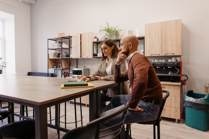 Two Colleagues Collaborating on a Project in a Modern Office Kitchen ...
