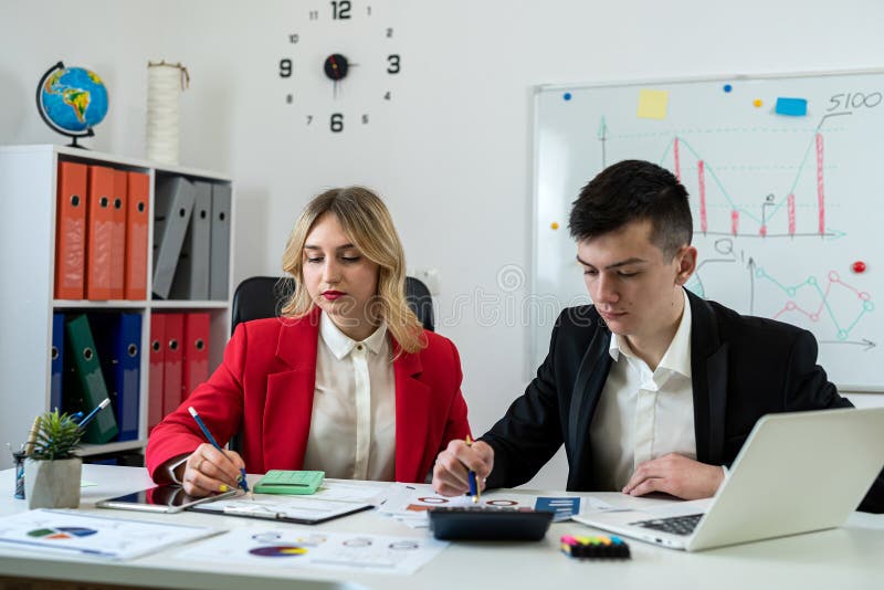 Two Colleagues Discussing Data Business Documents with Tablet and ...